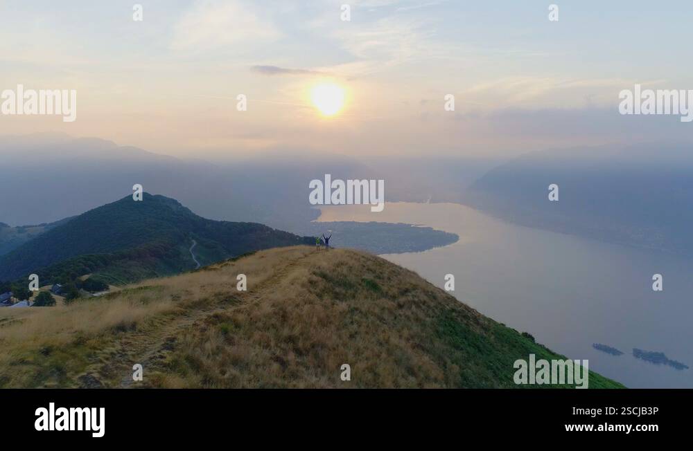 Drone shot aerial view of Father and daughter hiking on mountain top in ...