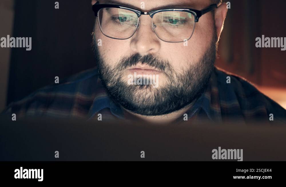 Serious man with reflection of laptop screen with website data in ...