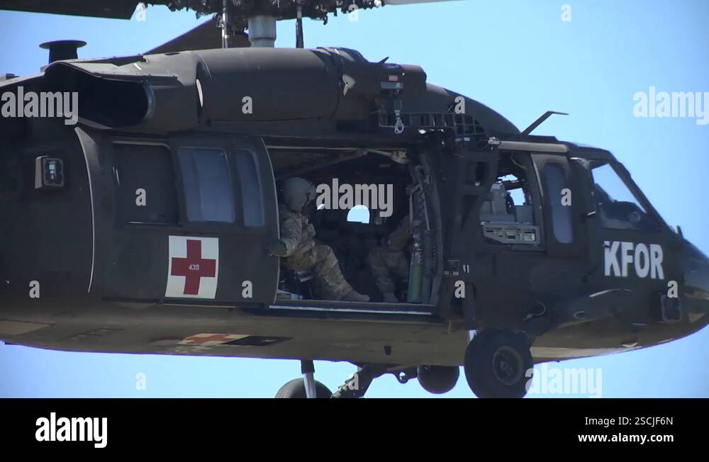 Soldier closing side door on UH-60 Black Hawk while hovering Stock Video Footage - Alamy