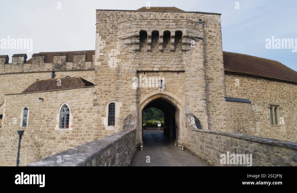 Castle entrance reveals large castle with moat and lawn area., drone ...