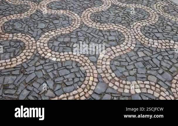 ripples pattern from mosaic cubes on black rough pavement. squares and ...