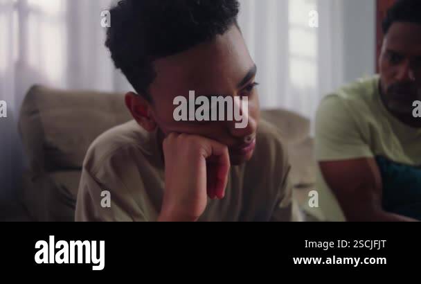 Teenage son showing disinterest and boredom during a conversation ...