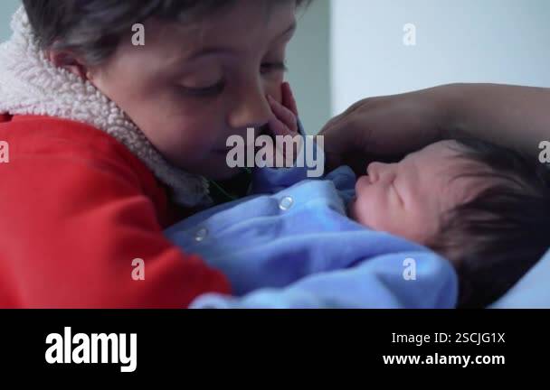 Big brother's tender moment with newborn sibling, focus on gentle touch ...