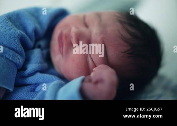 Close-up of newborn baby during first day of his life asleep after ...