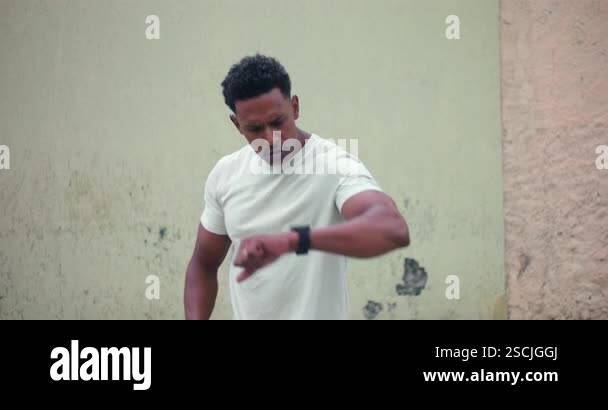 Man of African descent pointing at viewer while tapping wrist ...