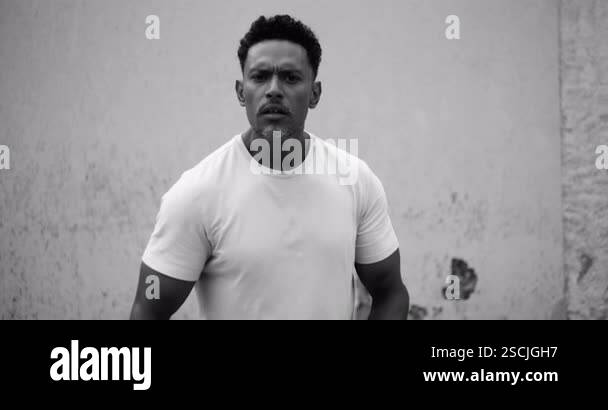 Man in fighting stance, fists raised, calling out the camera for a ...