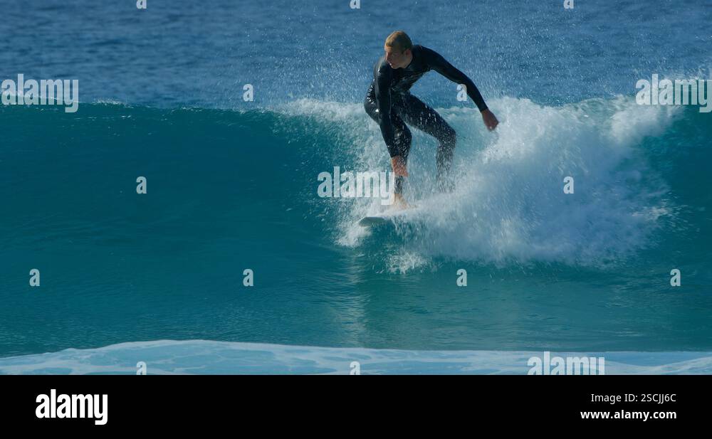 A Surfer puts his head in his hands and falls into water with injury ...