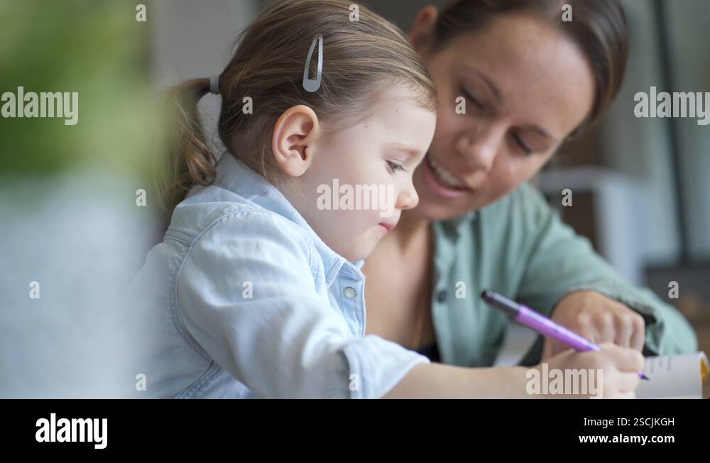 Mother teaching adorable young daughter how to draw and write at home Stock Video Footage - Alamy