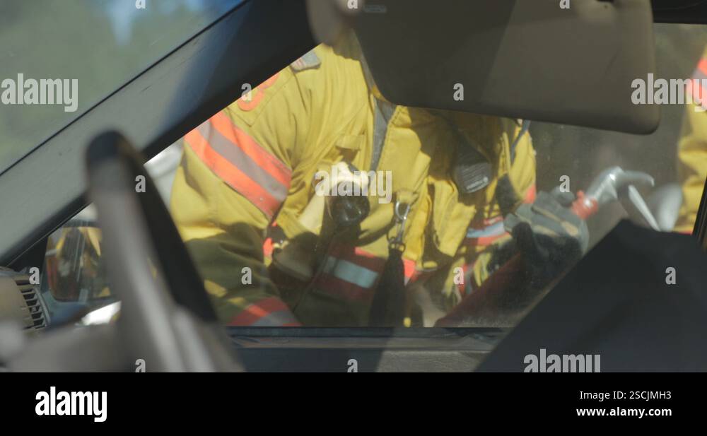 Firefighter uses tool to break open car window Stock Video Footage - Alamy
