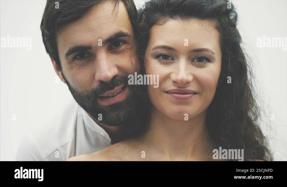 Beautiful elegant guy in a classic shirt with red roses in his hands ...