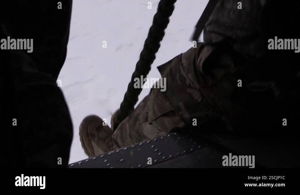 Soldiers fast roping from UH-60 Black Hawk onto snow in Alaska Stock ...