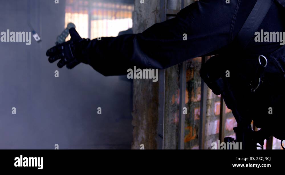 Rear view of caucasian soldier throwing grenade and firing on rubber ...