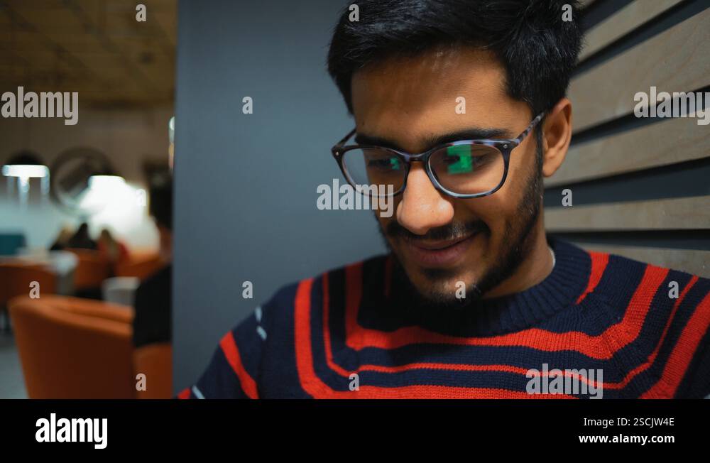 Close-up, Guy in Warm Sweater Writes a Message on Smartphone and Drinks ...