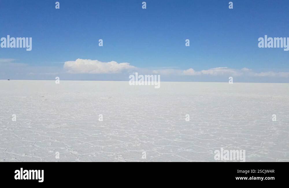 Driving through The Uyuni Salar in Bolivia. White salt flats and a ...