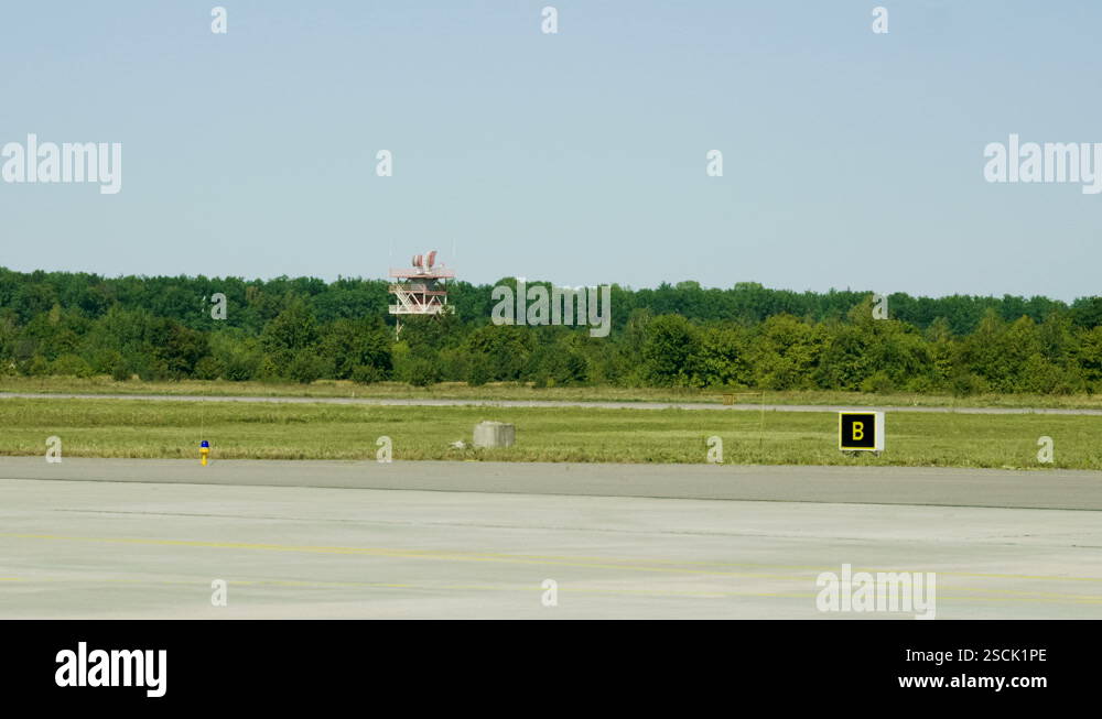 Rotating radar. Wide angle view of glide path beacon and runway. 4K ...