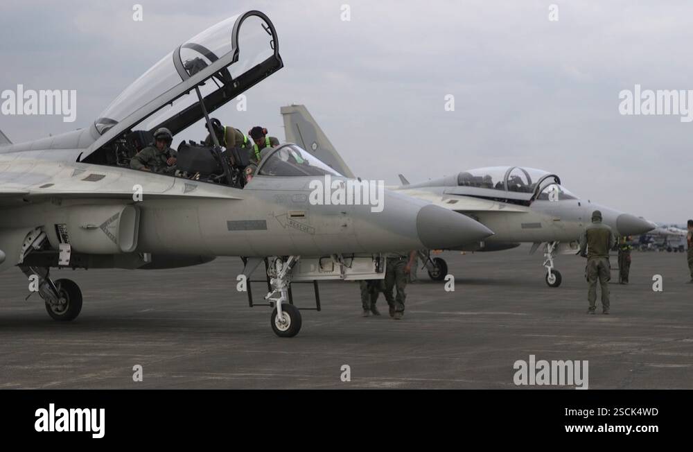 Ground crew assist FA-50 pilots to exit cockpit Stock Video Footage - Alamy