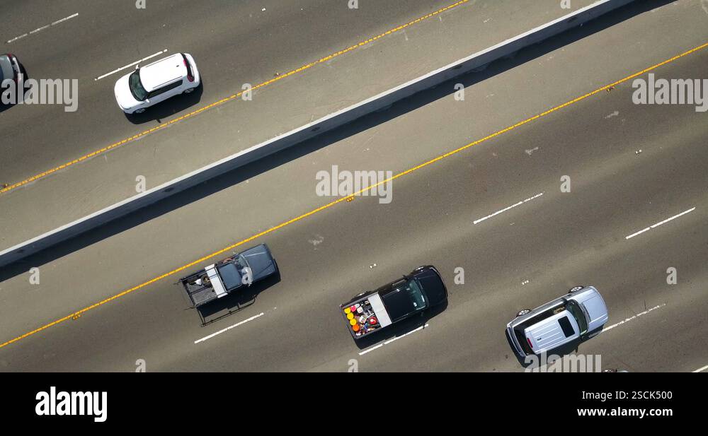 Cars speeding down 6 lane highway as seen from birds eye view above ...