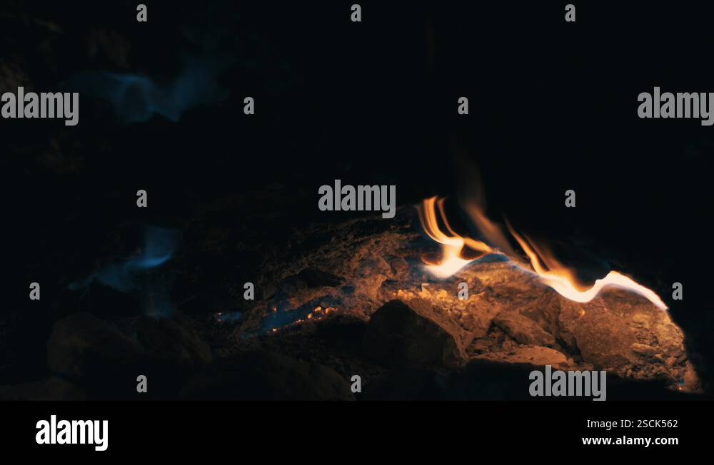 Chimera natural lights igniting bright in dark cave. Natural methane ...