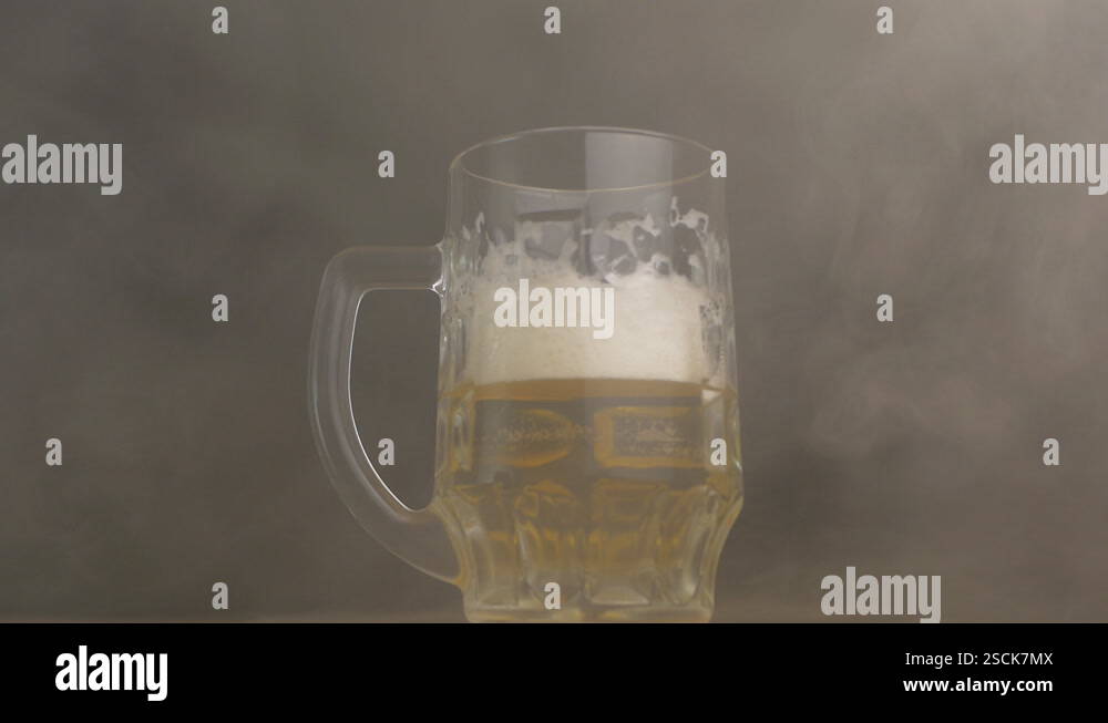 Twisted beer glass in which fresh beer is poured, smoke, freshness ...