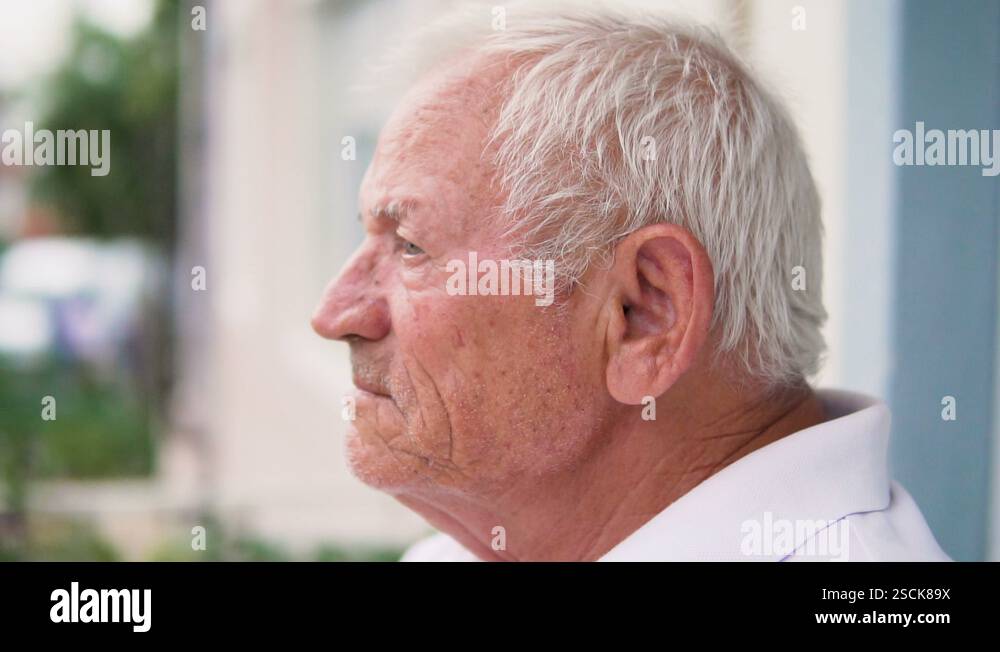 Portrait of sad old man looking at distance sitting outside, SLOW ...