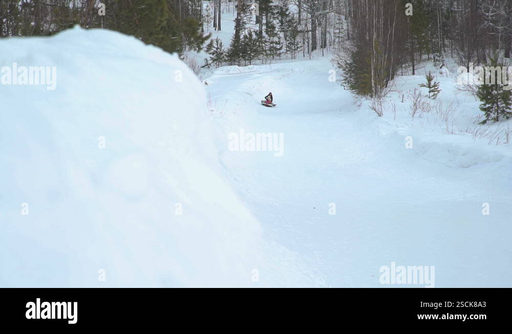 Girl and Woman Riding Fast on a Sledding Tubing Stock Video Footage - Alamy