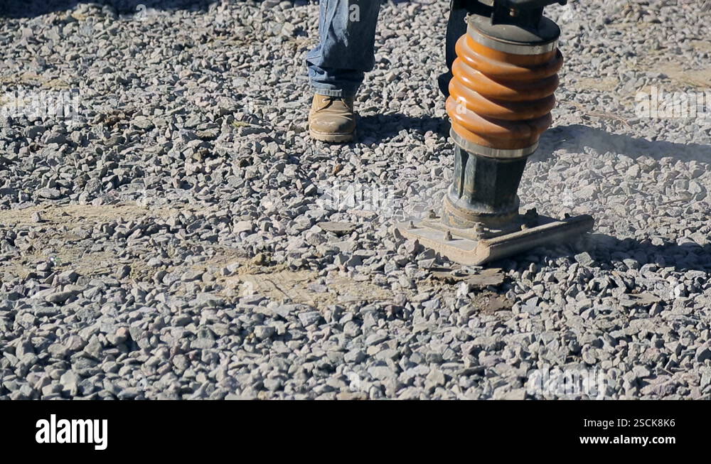 Worker operating a Vibratory Rammer Compactor.Vibratory rammer in ...