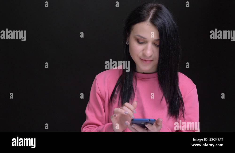 Closeup portrait of young modern caucasian female browsing on the phone ...