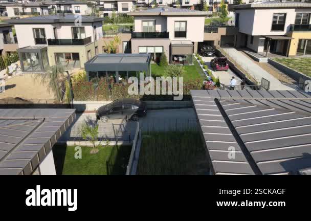 4K aerial footage of a sunny neighborhood villa with lush green yard ...