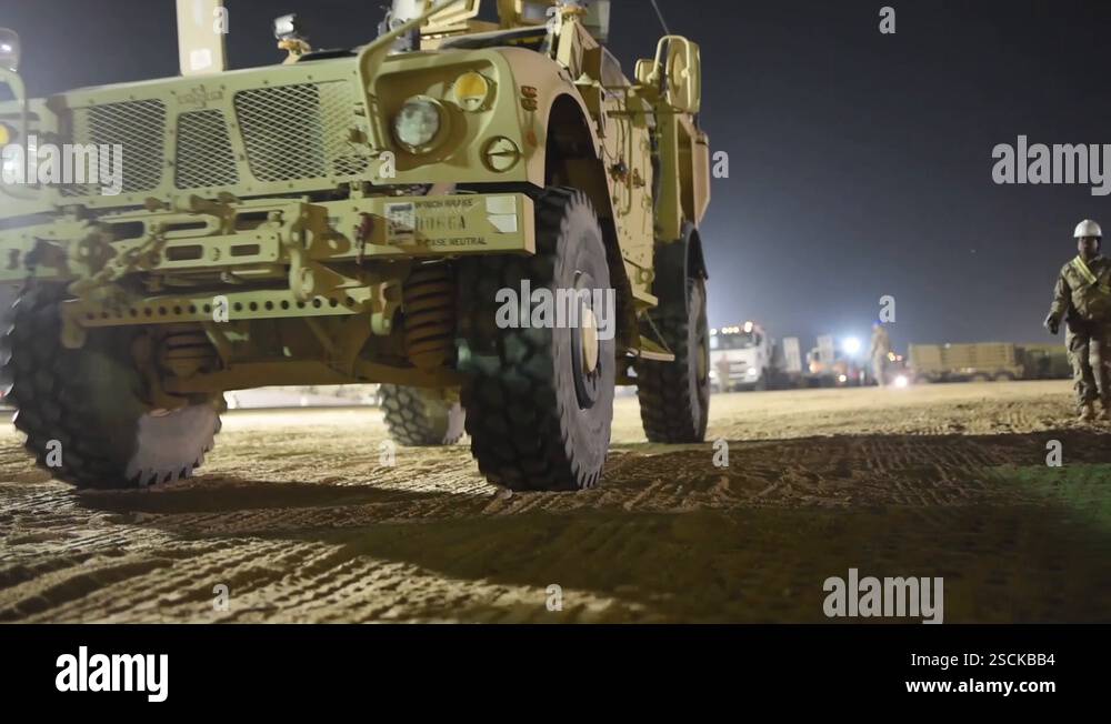 Military armoured vehicle driving over sand at Camp Buehring, Kuwait ...