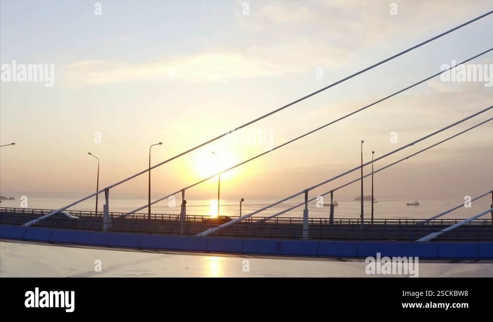 Flying sideways, aerial view of Russian bridge road with driving cars ...