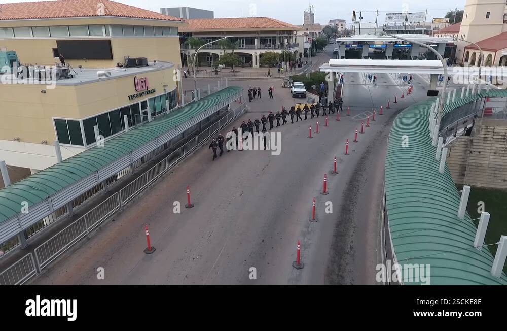 CBP officers walk with riot shields onto Gateway to the Americas Bridge ...