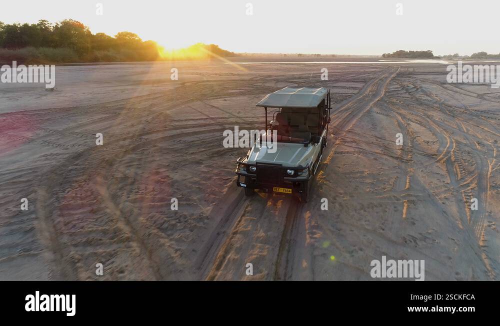 4K zoom out aerial view of a 4x4 vehicle riding on the banks and ...