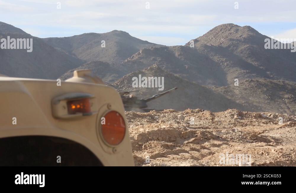 M1 Abrams tank tracking past parked Humvee at Twentynine Palms ...