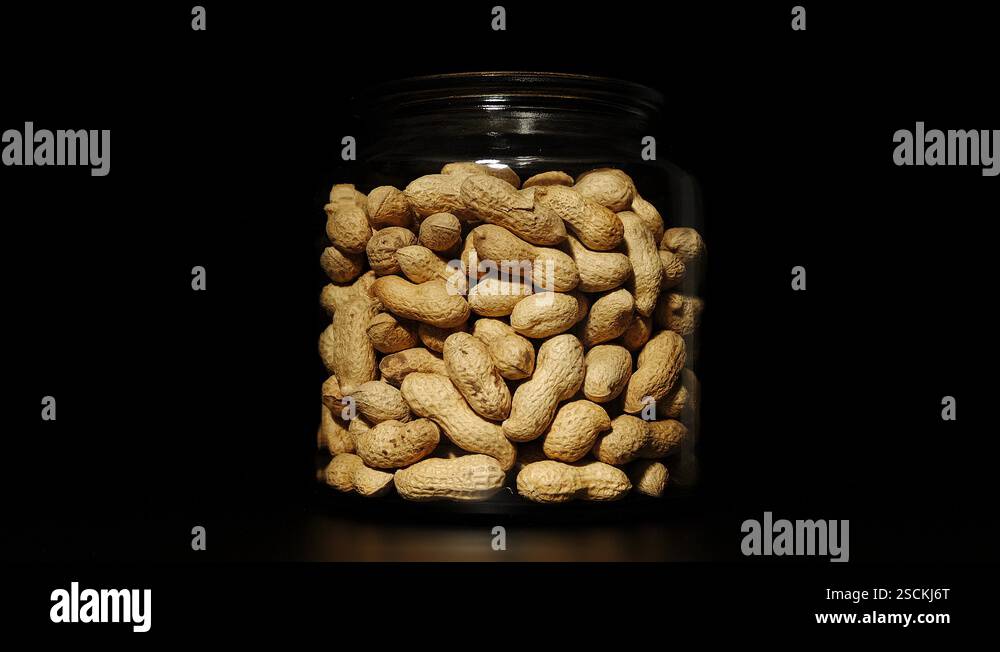 Unpeeled peanuts disappearing from a glass jar - Stop Motion Stock ...