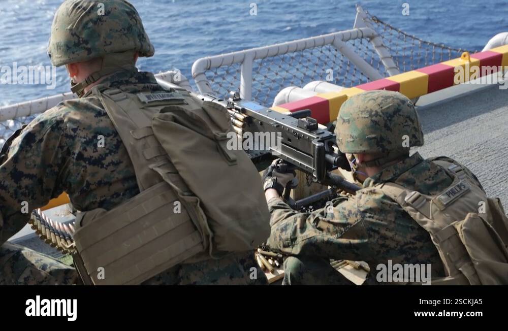 U.S. Marine firing machine gun from USS Wasp in Philippine Sea Stock ...