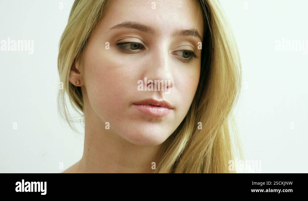 Portrait of beautiful young blonde woman with a sad look and natural ...