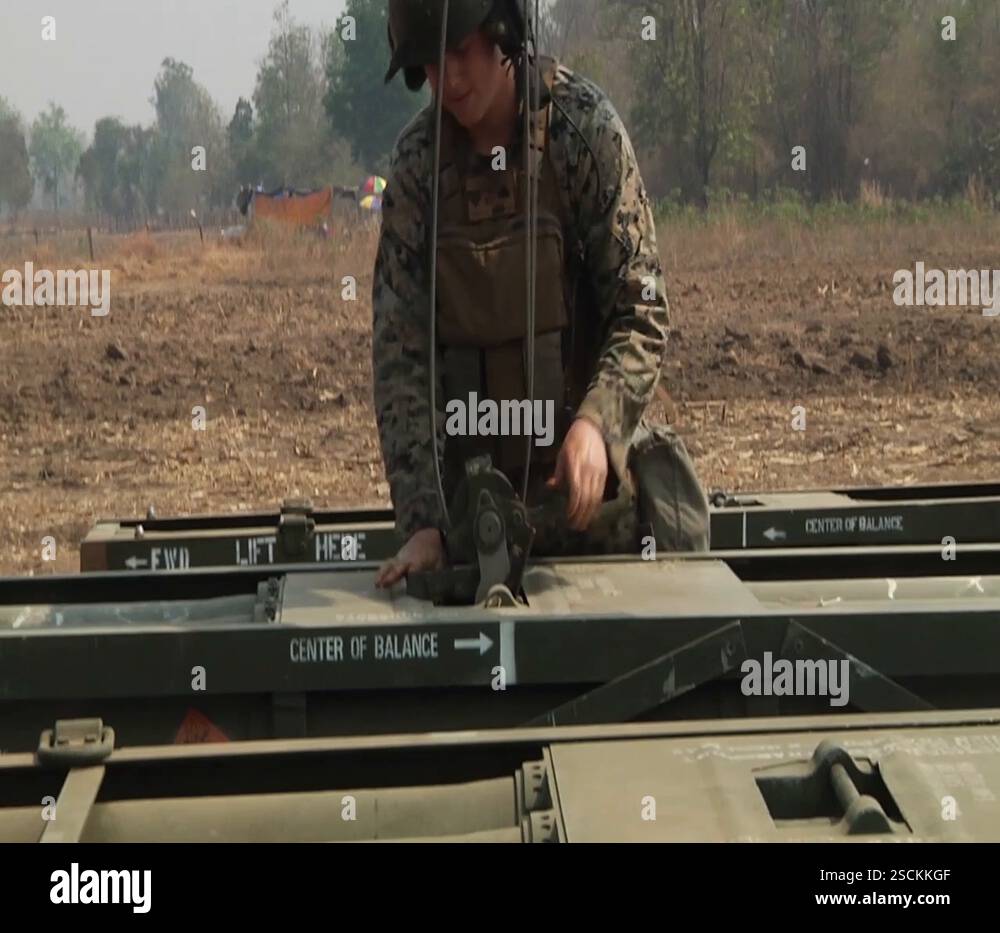Soldier attaching hoist to load ammunition into HIMARS during Cobra ...