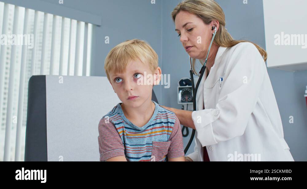 Little boy with a cough visiting female pediatrician to get flu ...