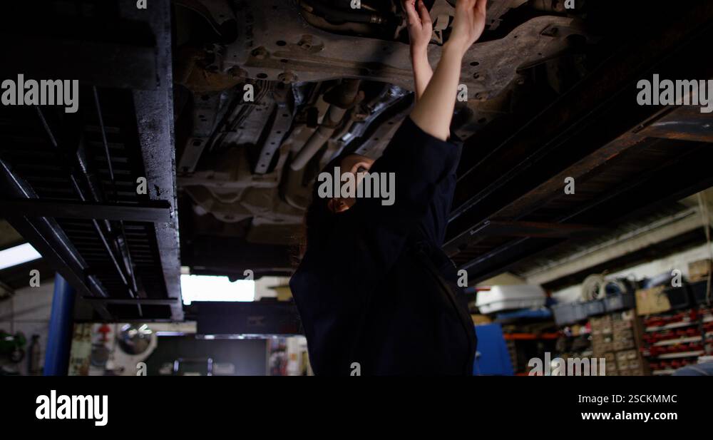 4K Female mechanic fixing a car in auto repair shop. Slow motion Stock ...