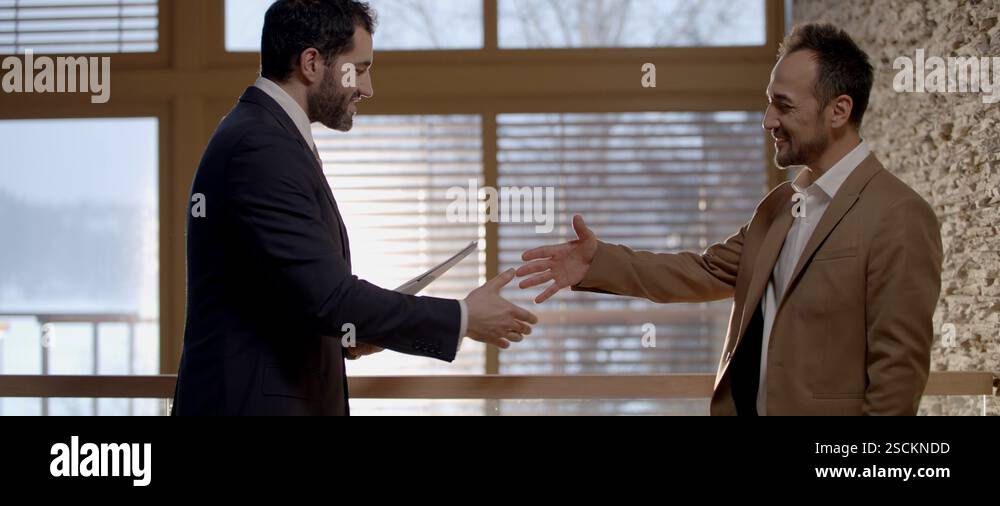 two businessmen discussing documents handshake Stock Video Footage - Alamy