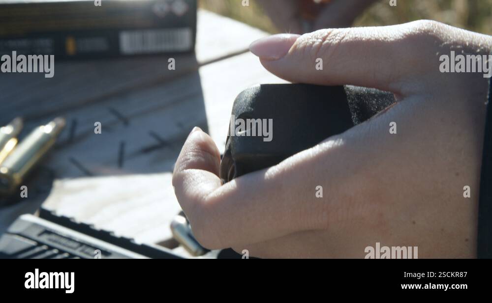 Female hands loading ammunition rounds into magazine Stock Video ...