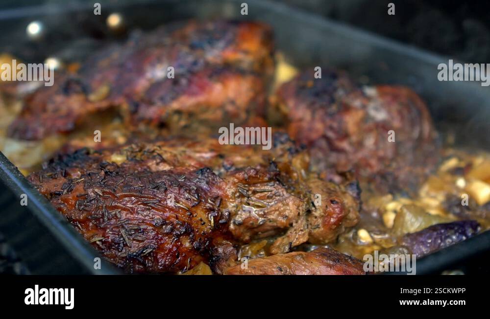 Slow Motion of chef cooking pork being grilled on barbecue. Roast pig ...