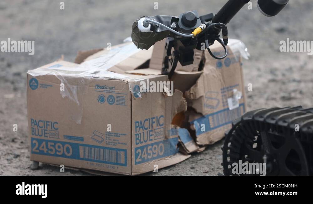 EOD robot, The Talon, opening box with suspect improvised explosives ...