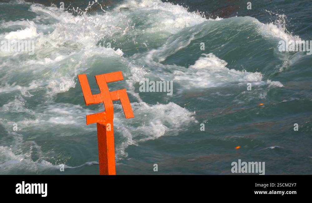 Hindu swastika sign and Hindu pilgrims bathing on the Ganges river ...