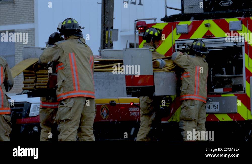 Hamilton, Canada 2019: Fire brigade packing up a fire hose after ...