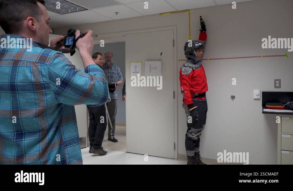 NASA astronaut being photographed against measuring chart Stock Video ...
