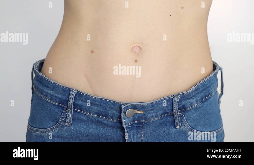 slim girl in too big jeans showing her belly Stock Video Footage - Alamy