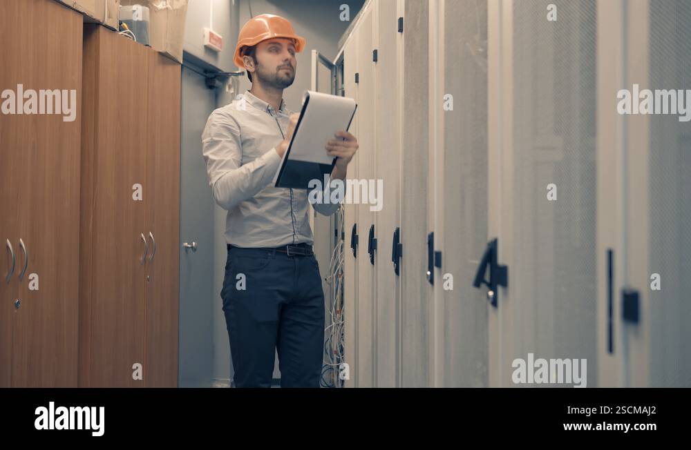 Man IT Engineer In Helmet Working In Server Room.Technical Engineer ...
