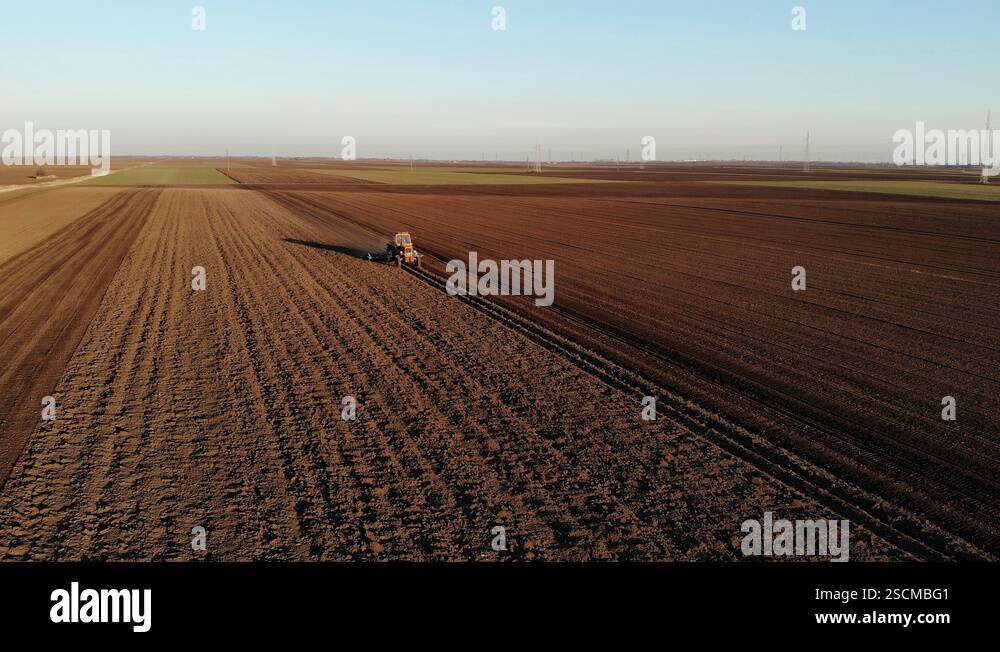 Aerial drone view Tractor in soil field Stock Video Footage - Alamy