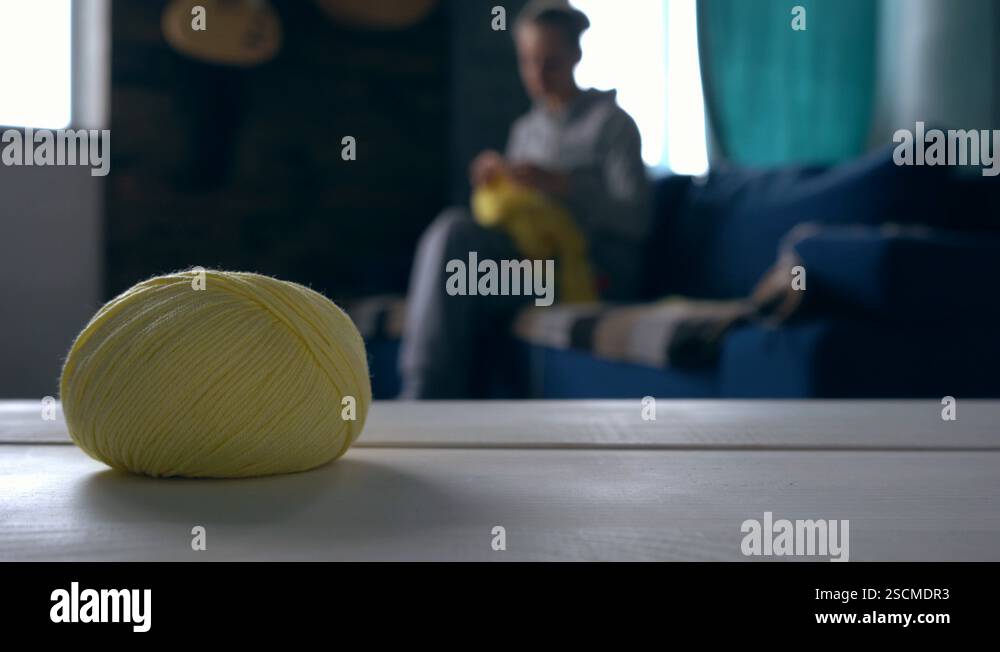 Woman sitting on the sofa and engaging in a hobby at home, she is ...